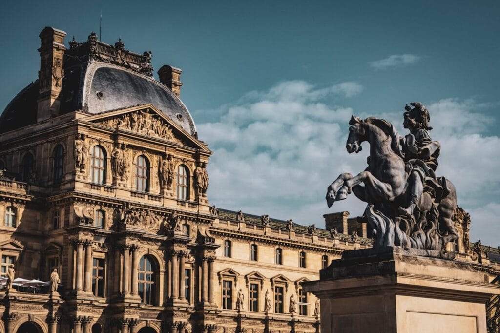 What materials were used to build the Louvre over the centuries